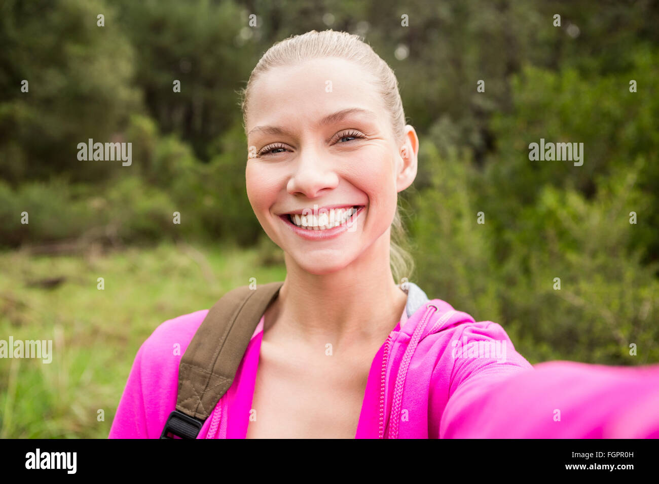 Smiling female hiker taking a selfie Stock Photo - Alamy