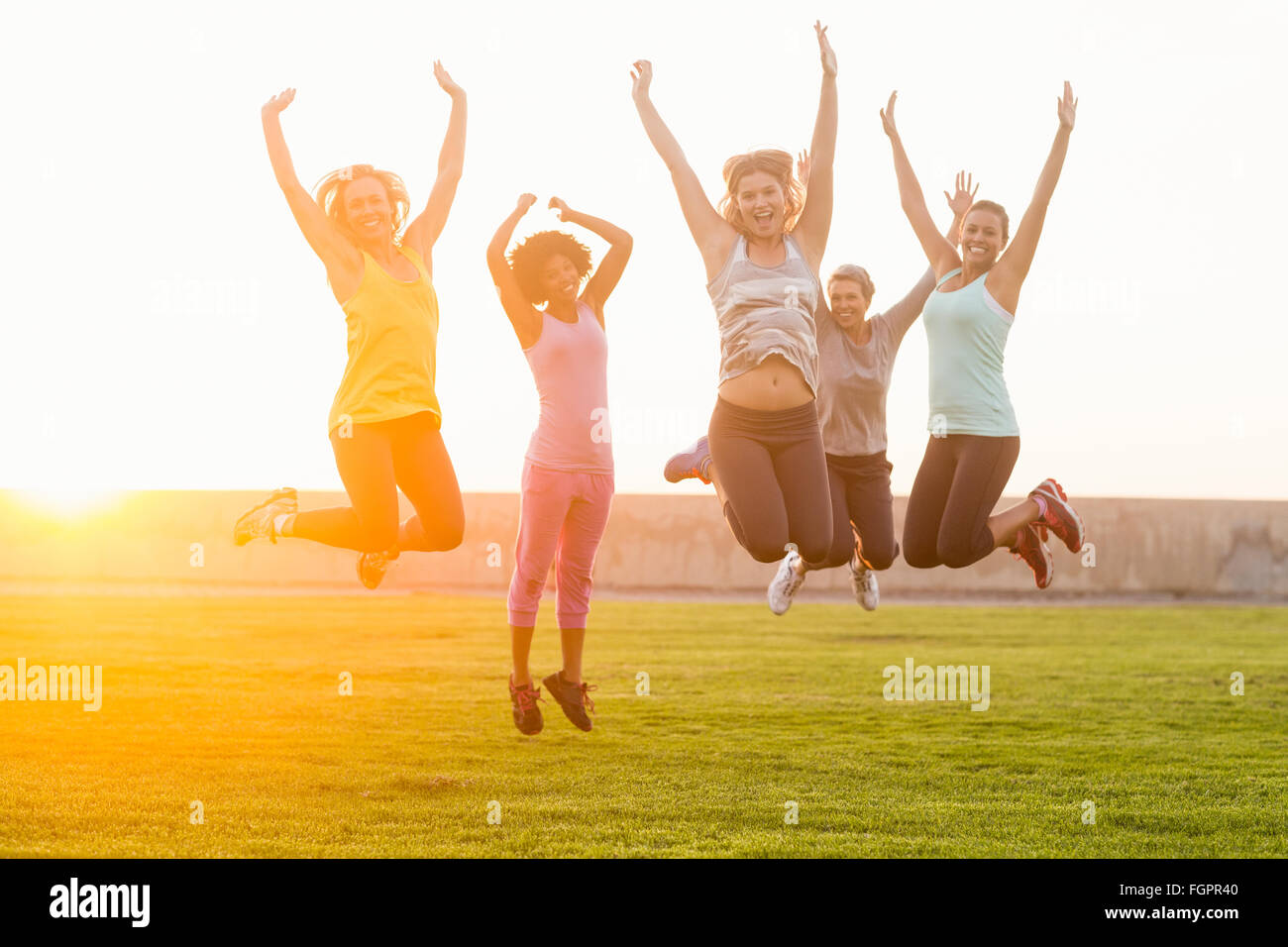 Happy sporty women jumping during fitness class Stock Photo - Alamy