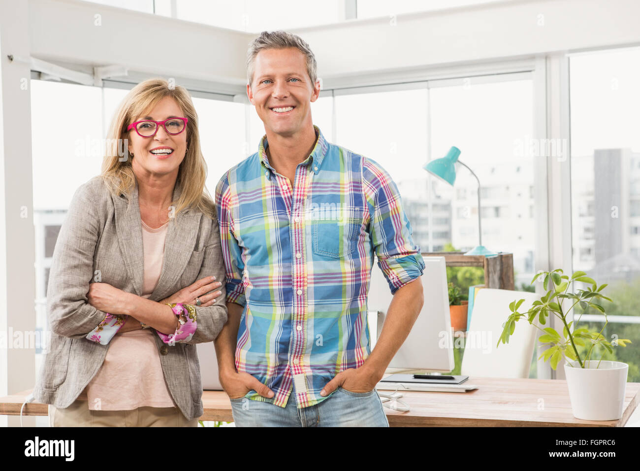 Creative design team smiling at camera Stock Photo - Alamy