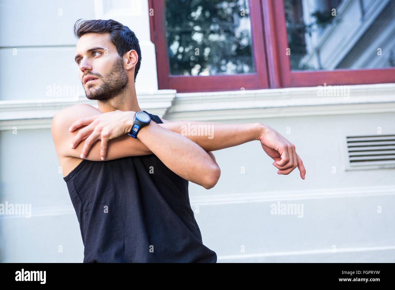 Handsome athlete stretching his arm Stock Photo - Alamy