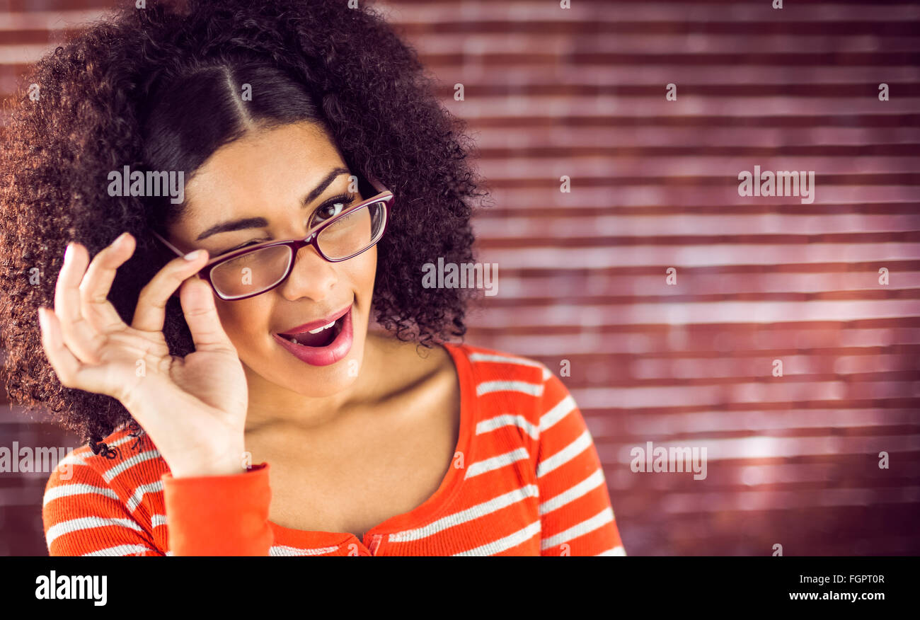 Attractive young woman winking Stock Photo - Alamy