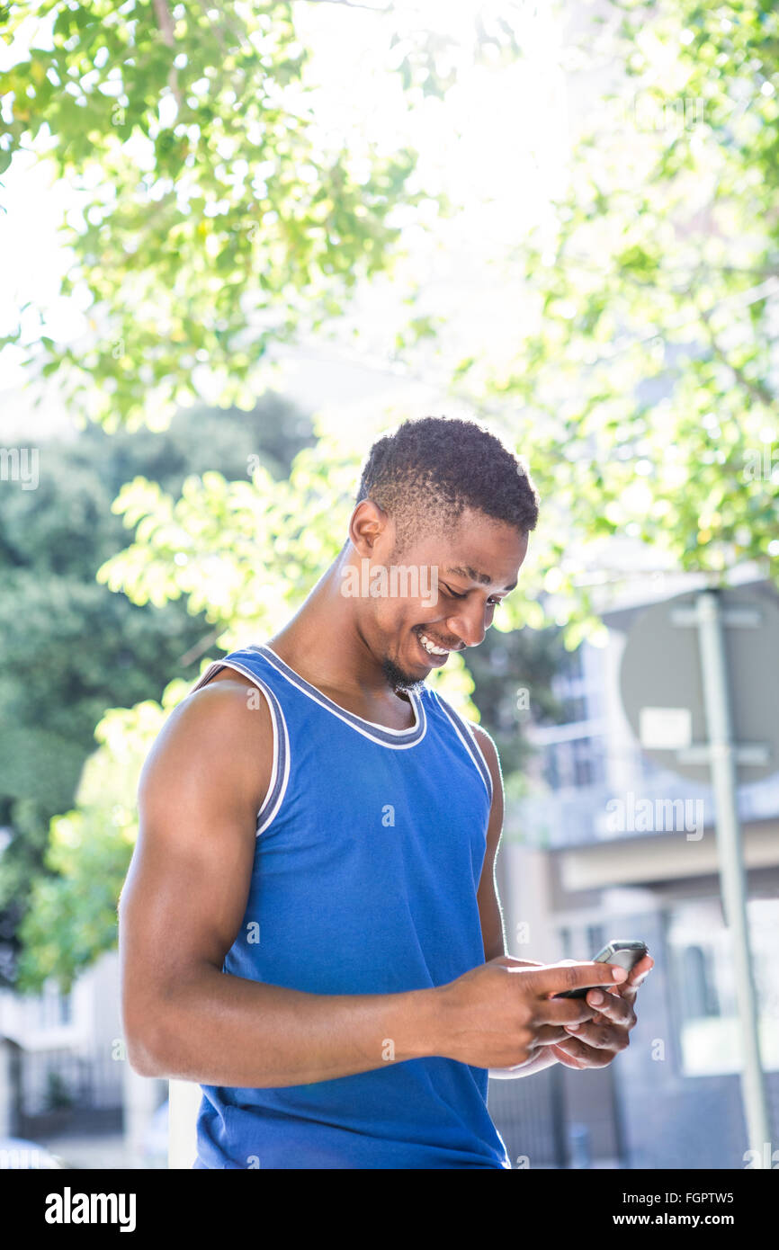An handsome athlete using his phone Stock Photo - Alamy