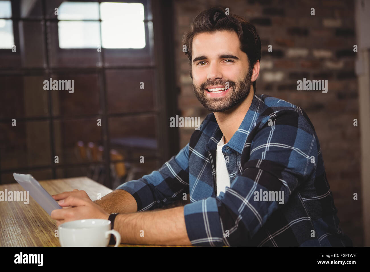 Young man using his tablet Stock Photo - Alamy