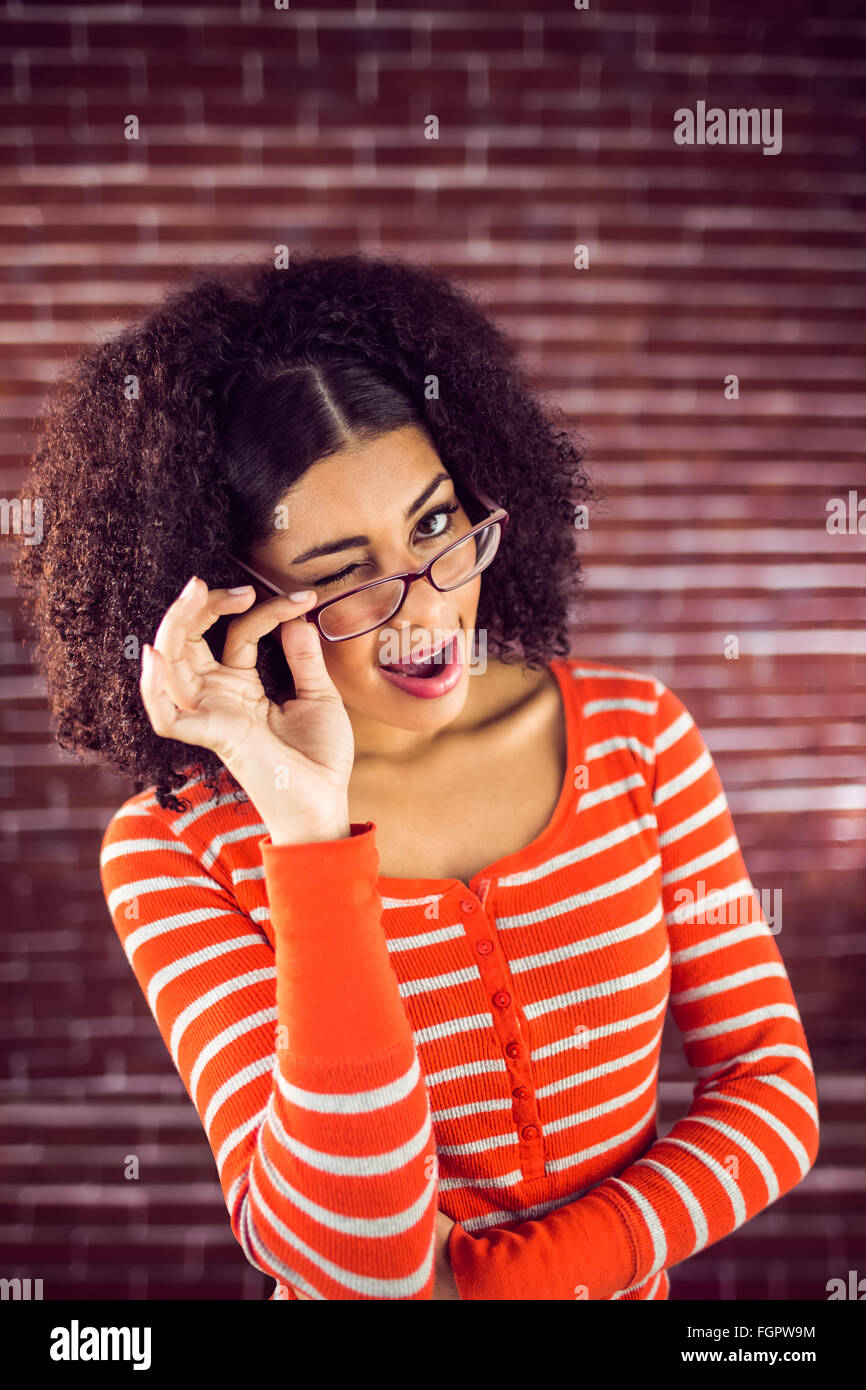 Attractive young woman winking Stock Photo - Alamy