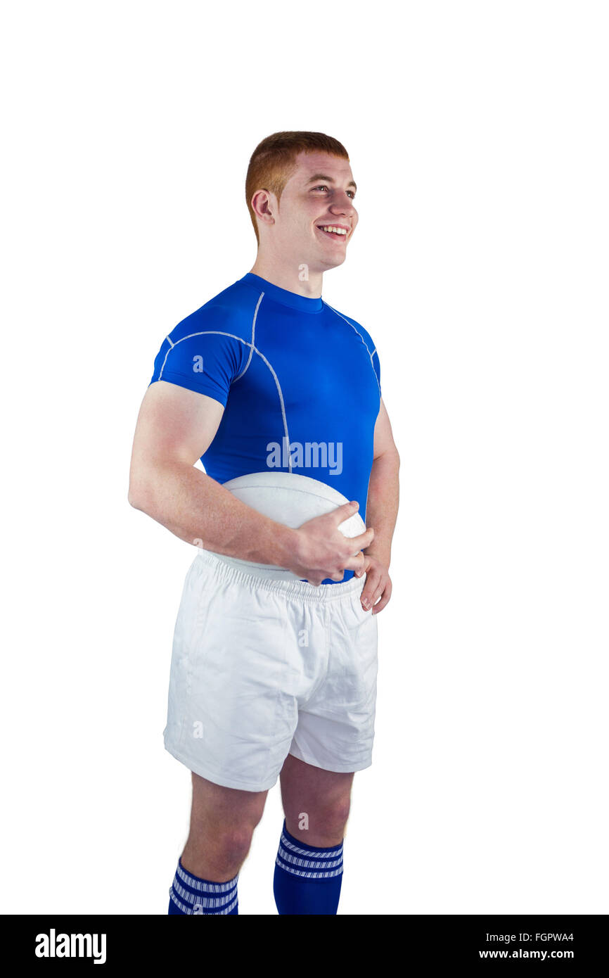 Smiling rugby player holding rugby ball Stock Photo - Alamy