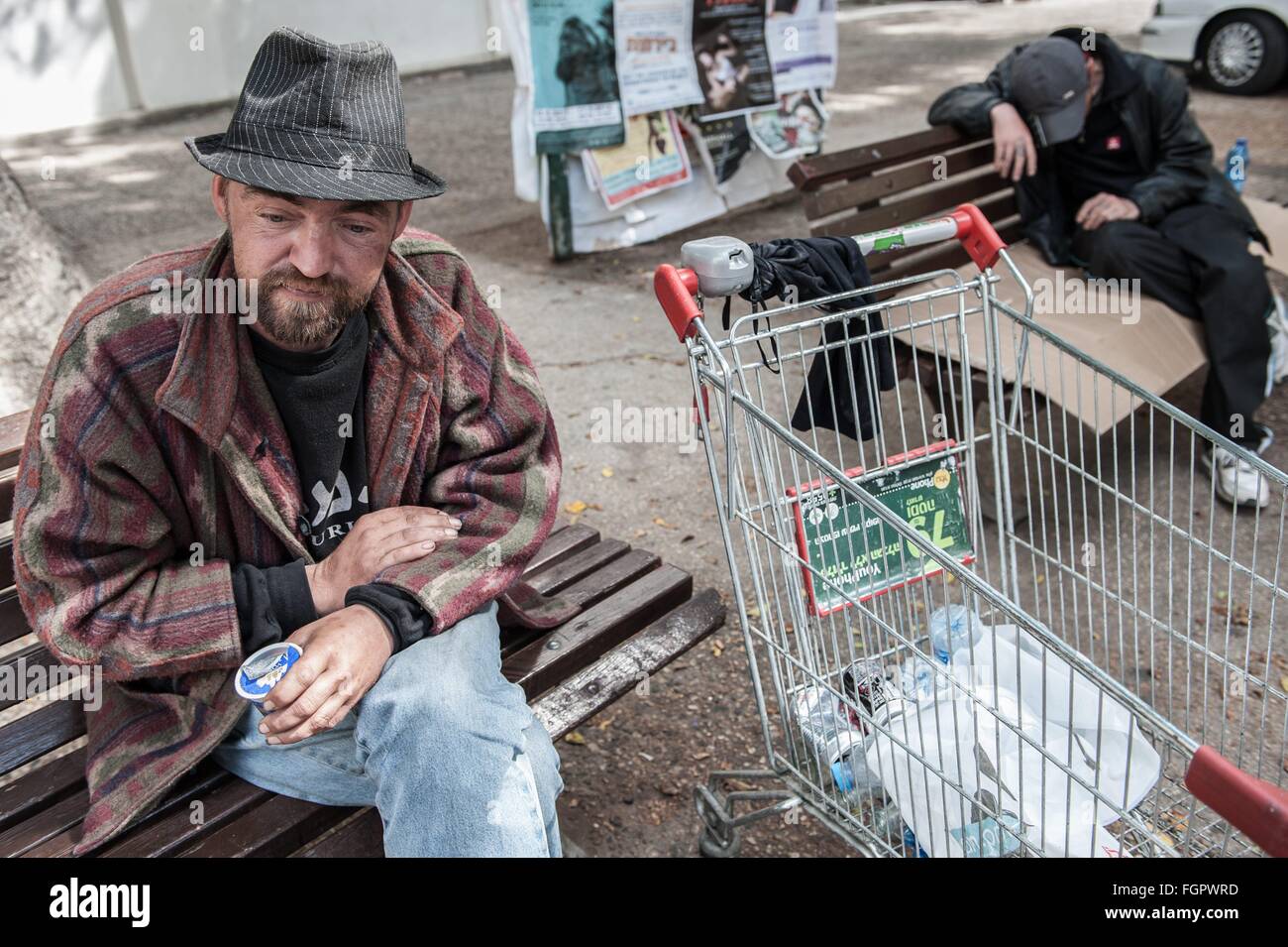 Russian Israeli homeless people sitting on benches in a public park ...