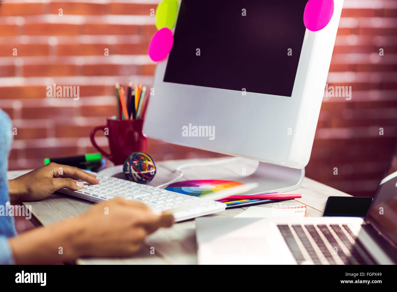 Graphic designer working at desk Stock Photo - Alamy