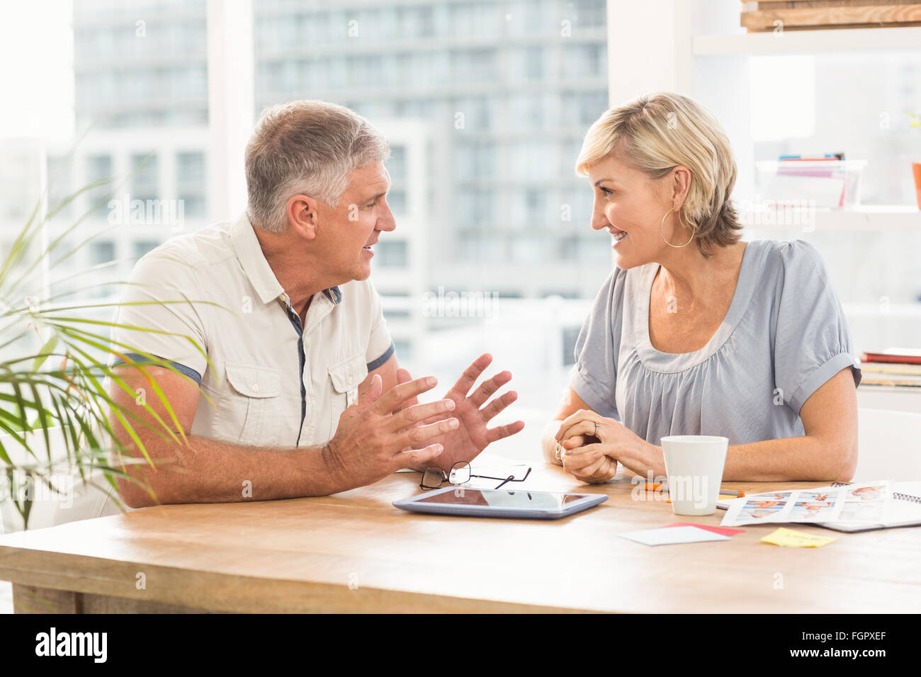 Smiling business team discussing together Stock Photo - Alamy