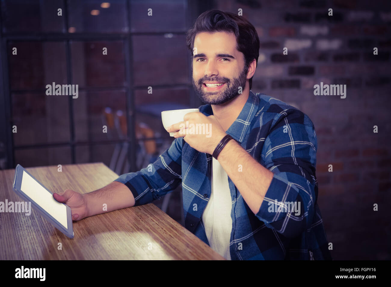 Young man using his tablet Stock Photo - Alamy