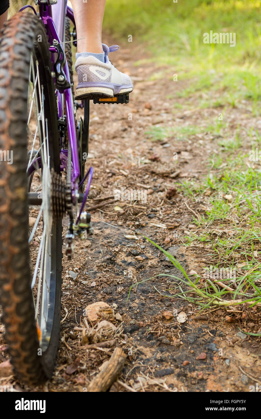 Close up view of woman pedaling on mountain bike Stock Photo - Alamy