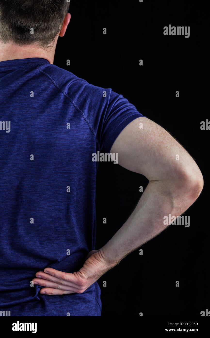 Rear view of a man with back pain over Stock Photo - Alamy
