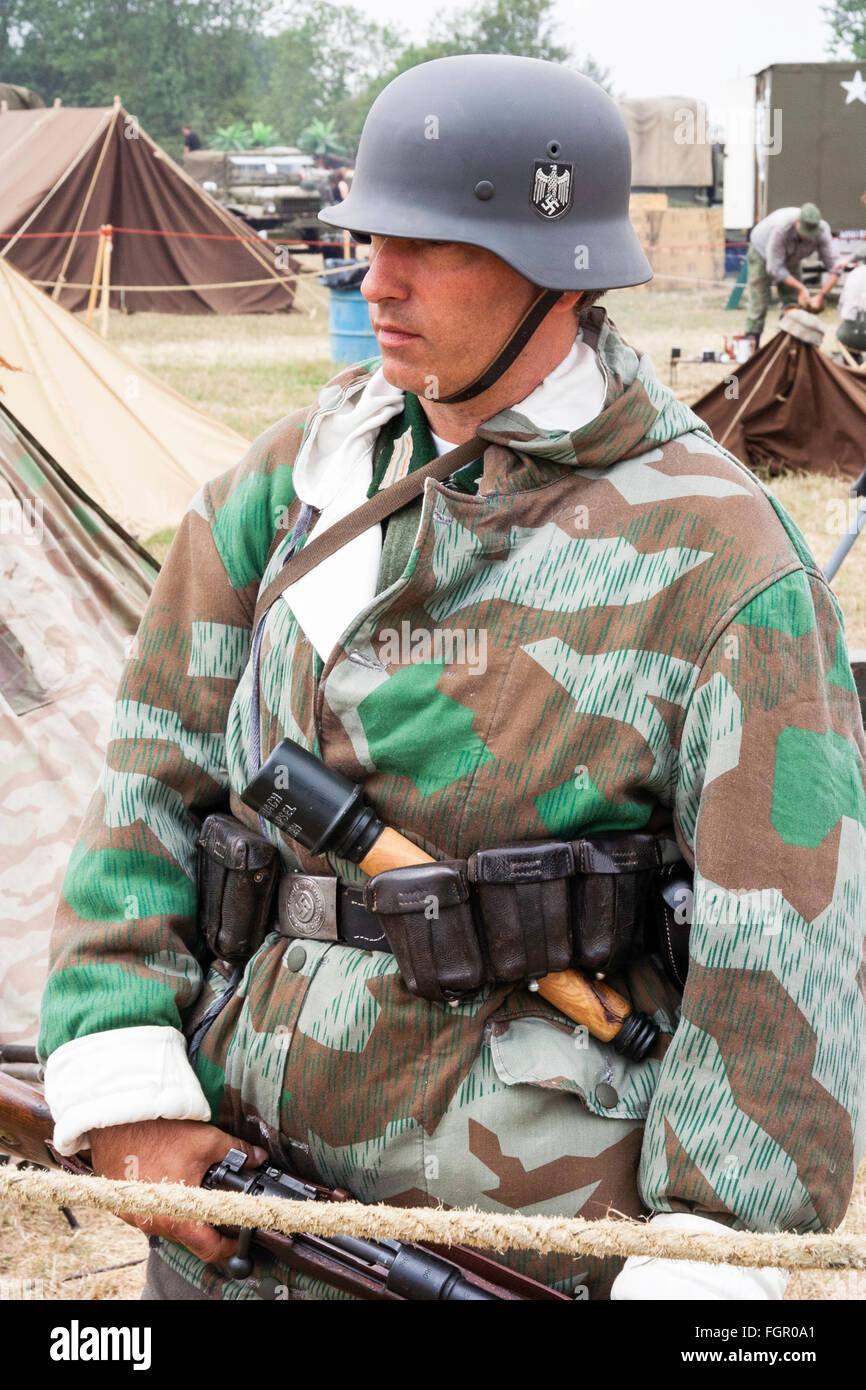 Second world war re-enactment. German sentry in camouflage smock, stick ...