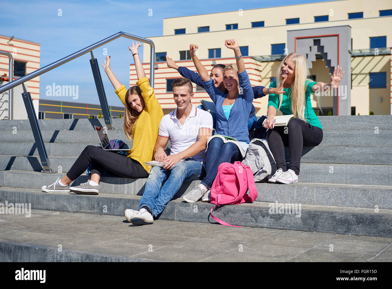 students outside sitting on steps Stock Photo - Alamy