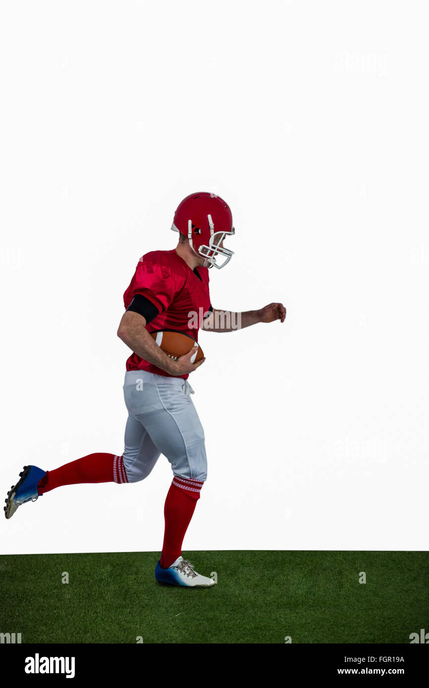 American football player running with football Stock Photo - Alamy