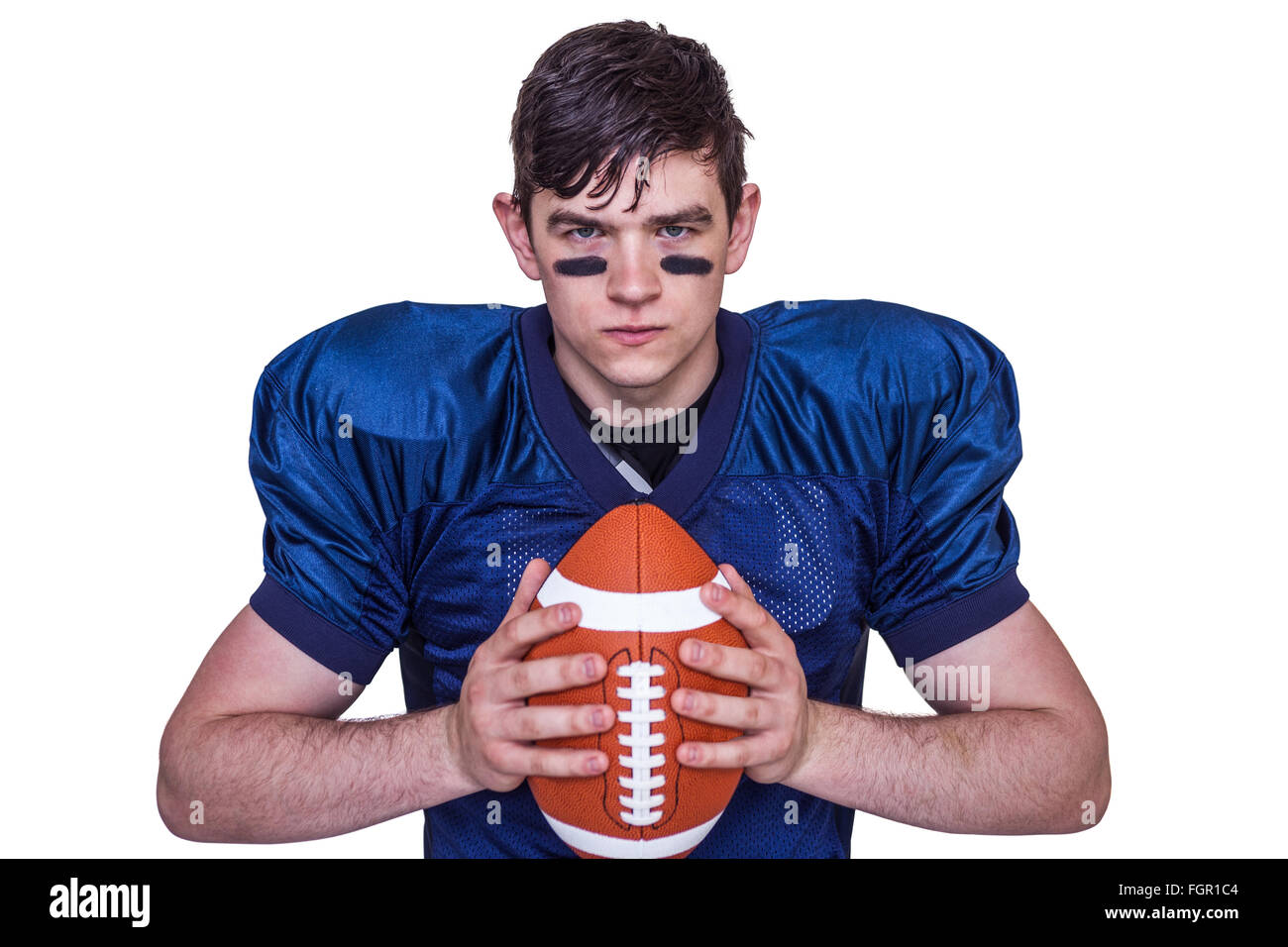 Determined american football player holding a ball Stock Photo - Alamy