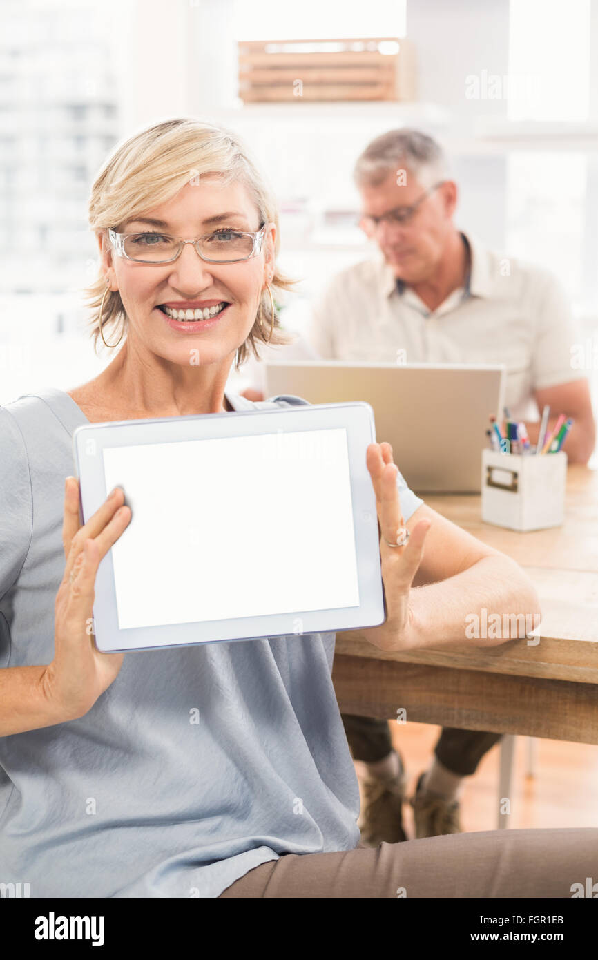 Smiling businesswoman showing her tablet Stock Photo - Alamy