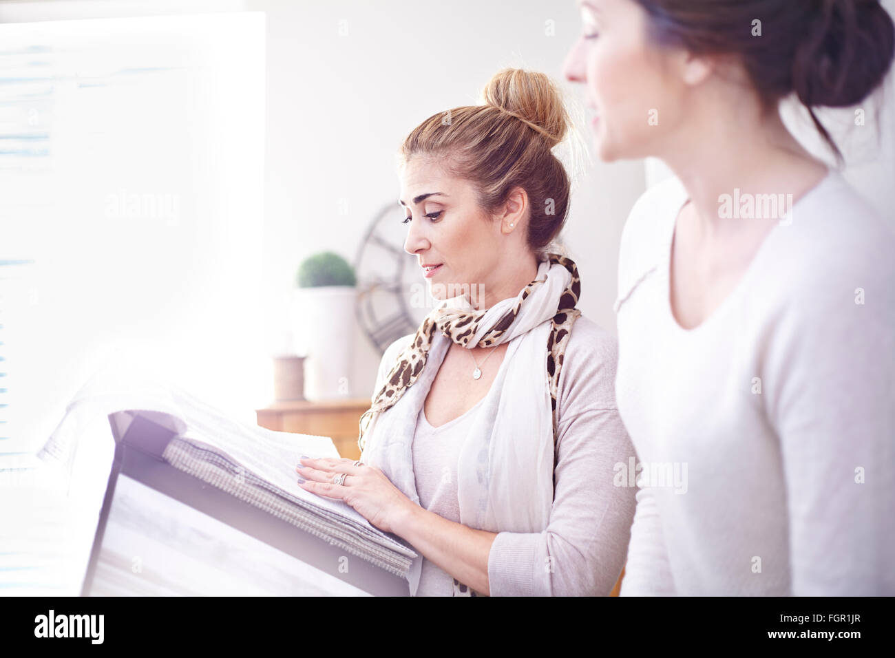 Interior designers browsing fabric swatches in office Stock Photo - Alamy