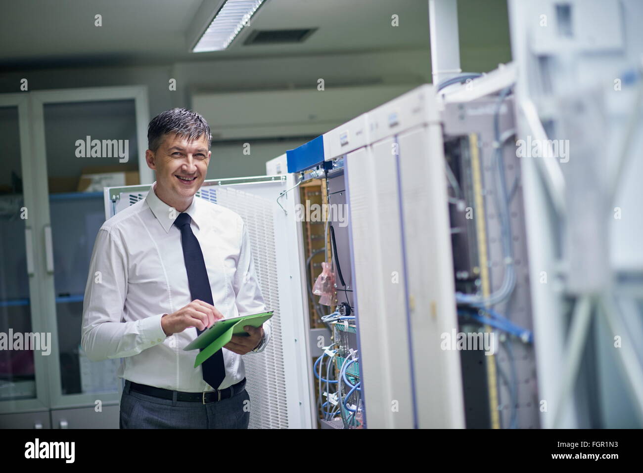 network engineer working in server room Stock Photo - Alamy