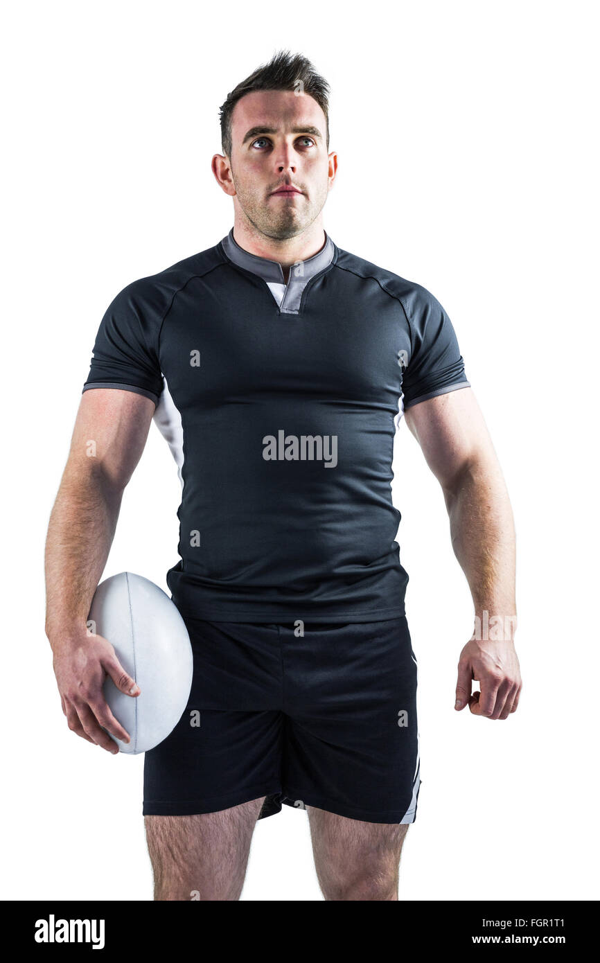 Tough rugby player holding ball Stock Photo - Alamy