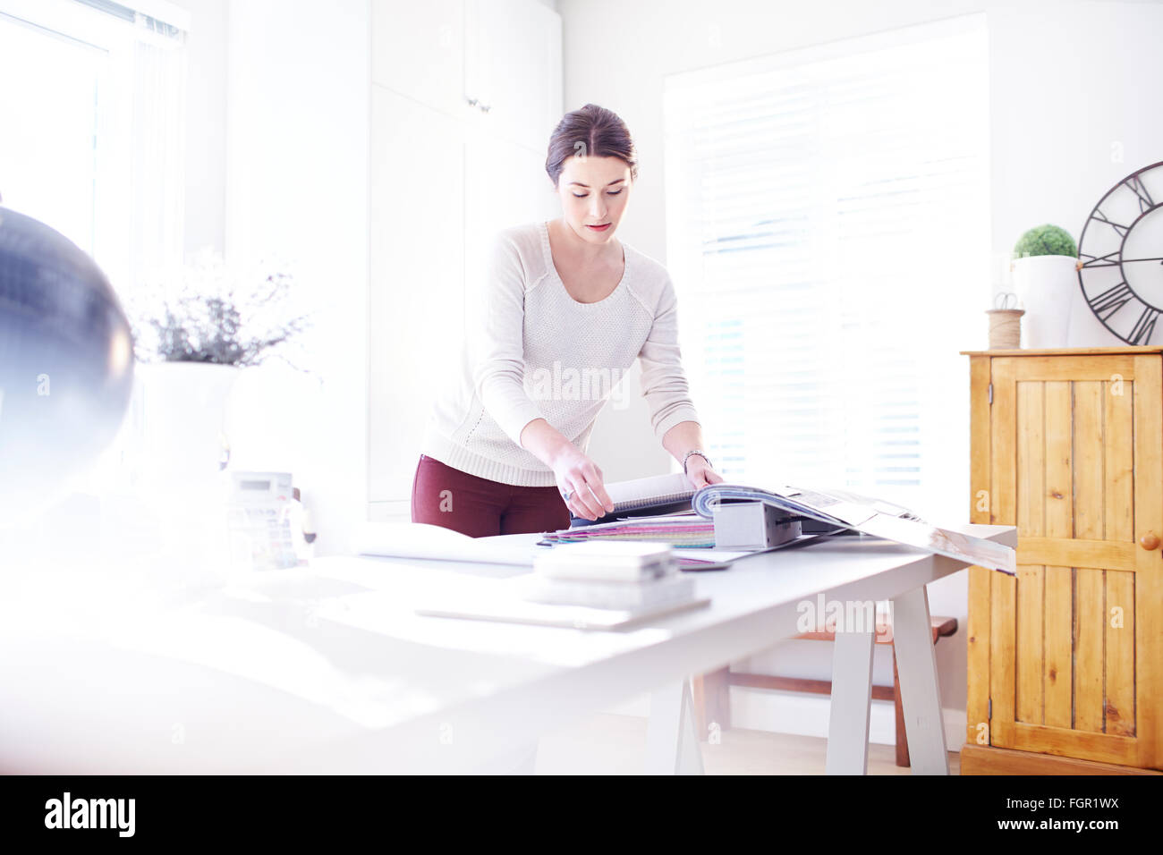 Interior designer browsing fabric swatches in office Stock Photo - Alamy