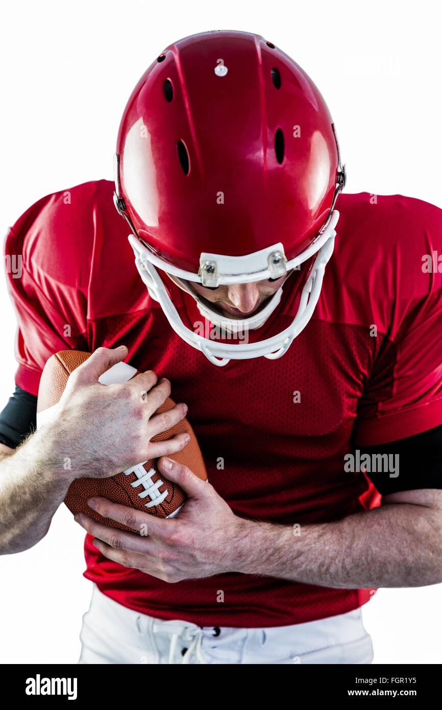 American football player protecting football Stock Photo - Alamy