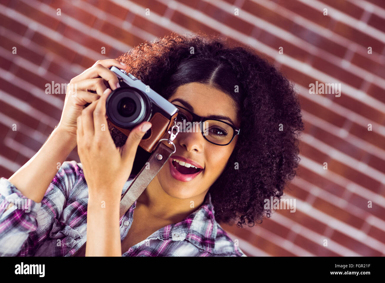 Attractive hipster photographing with camera Stock Photo - Alamy