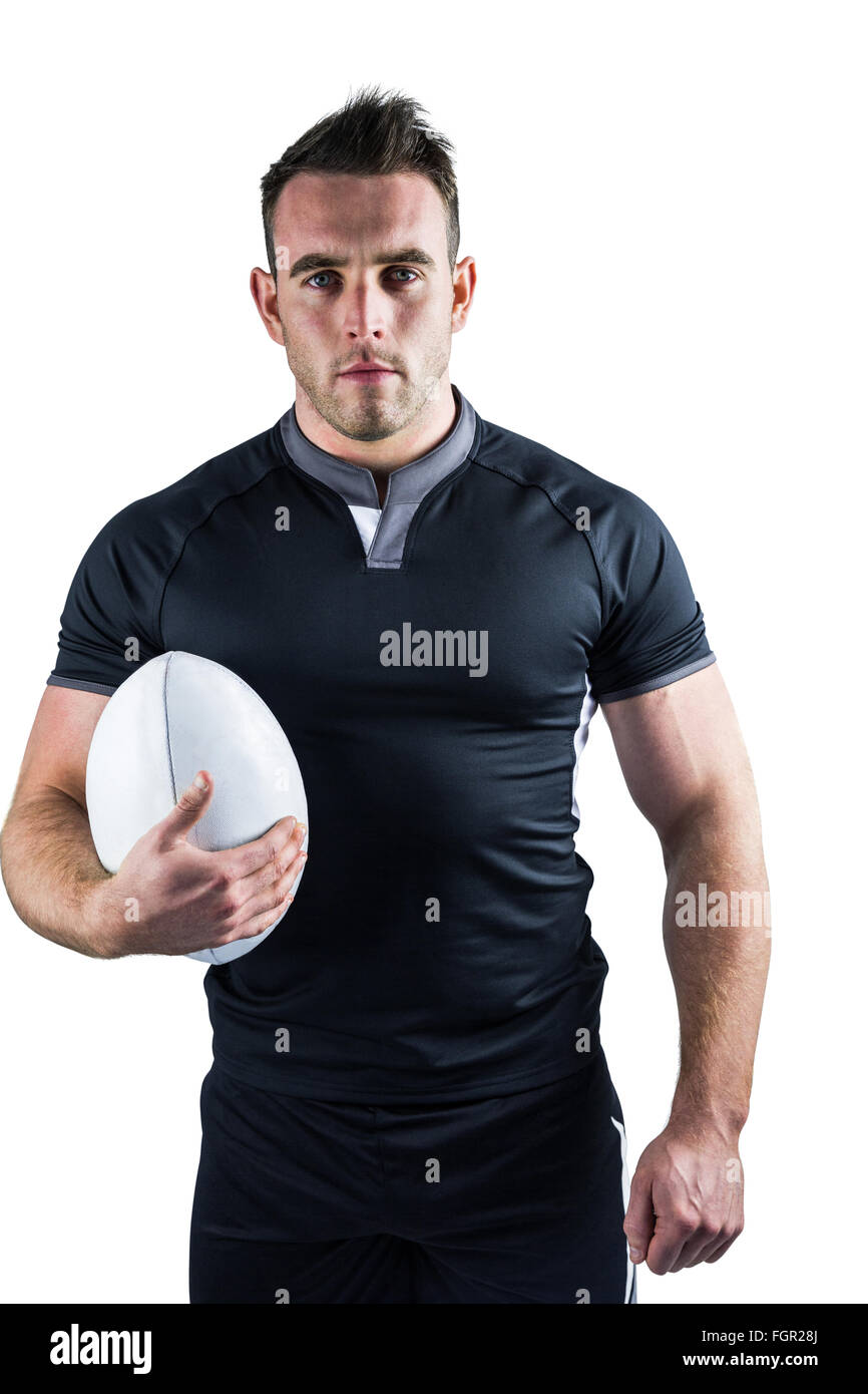 Tough rugby player holding ball Stock Photo - Alamy