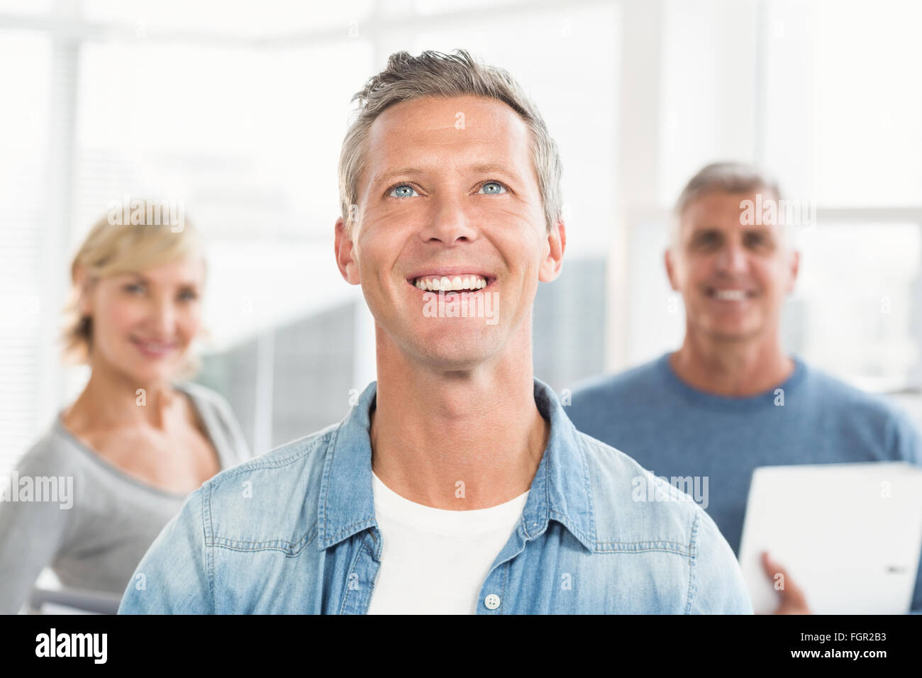 Smiling business colleagues holding workbooks Stock Photo - Alamy