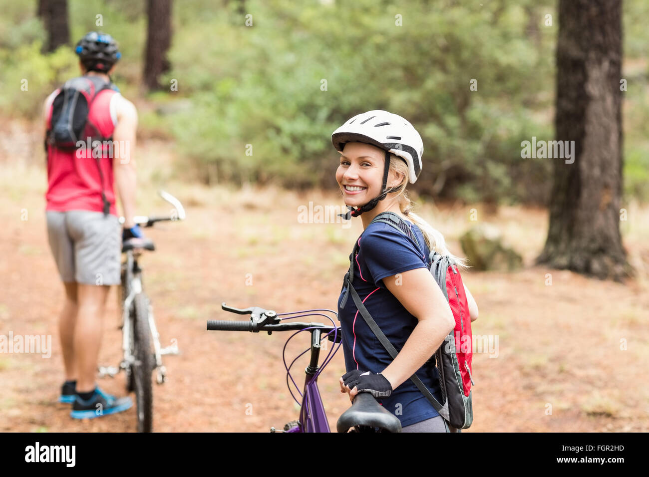 Pretty biker looking at camera Stock Photo - Alamy