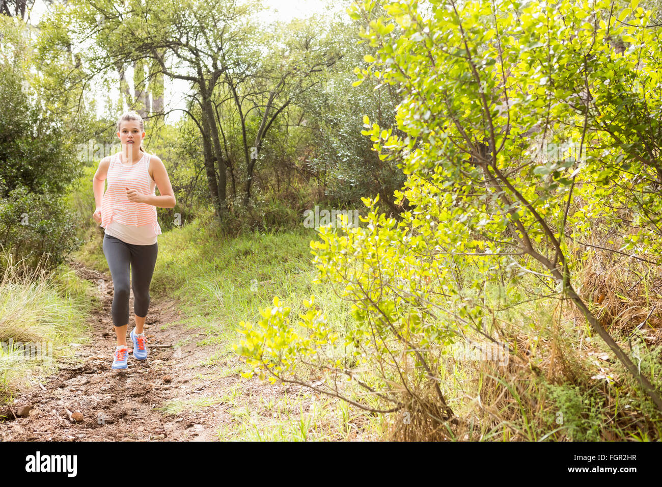 Blonde athlete jogging on trail Stock Photo - Alamy