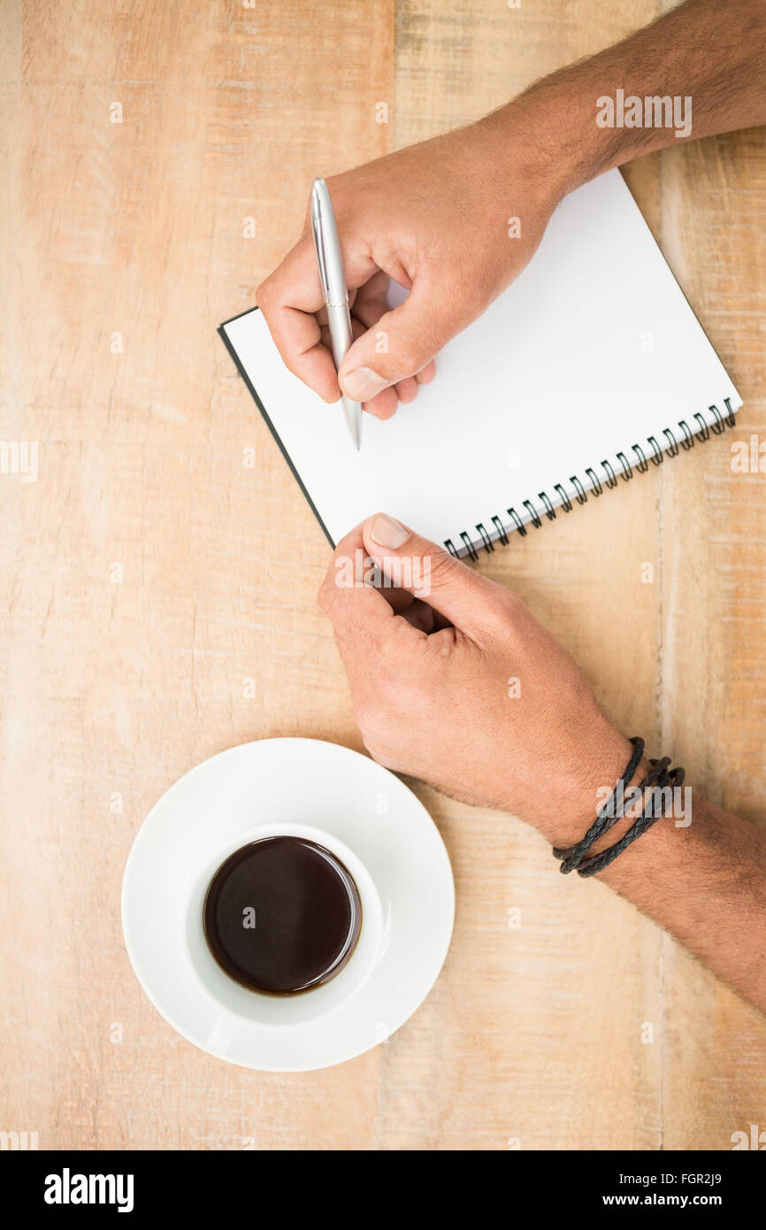 Hands writing on notepad Stock Photo - Alamy