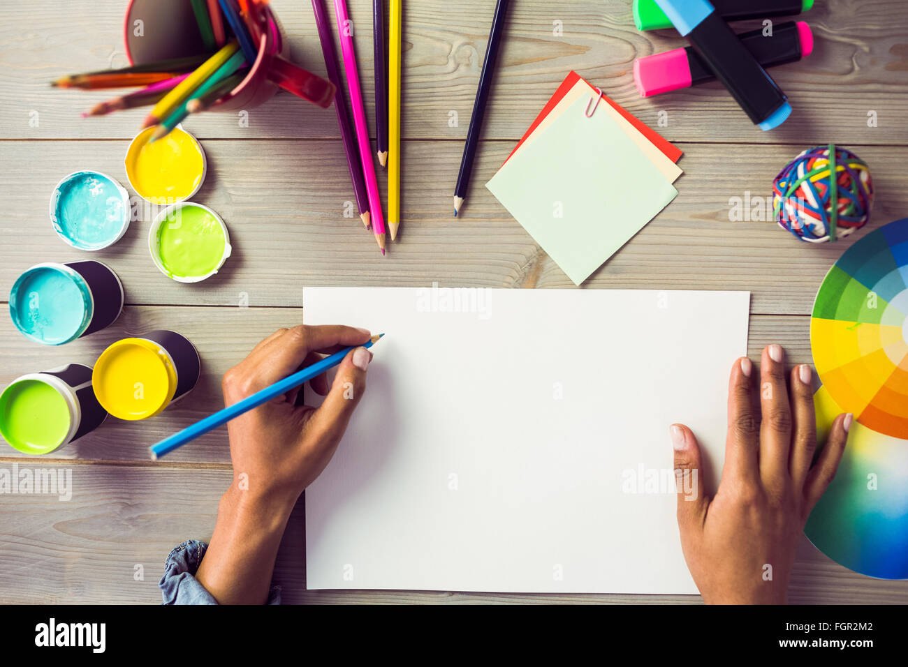 Graphic designer drawing on sheet of paper Stock Photo - Alamy