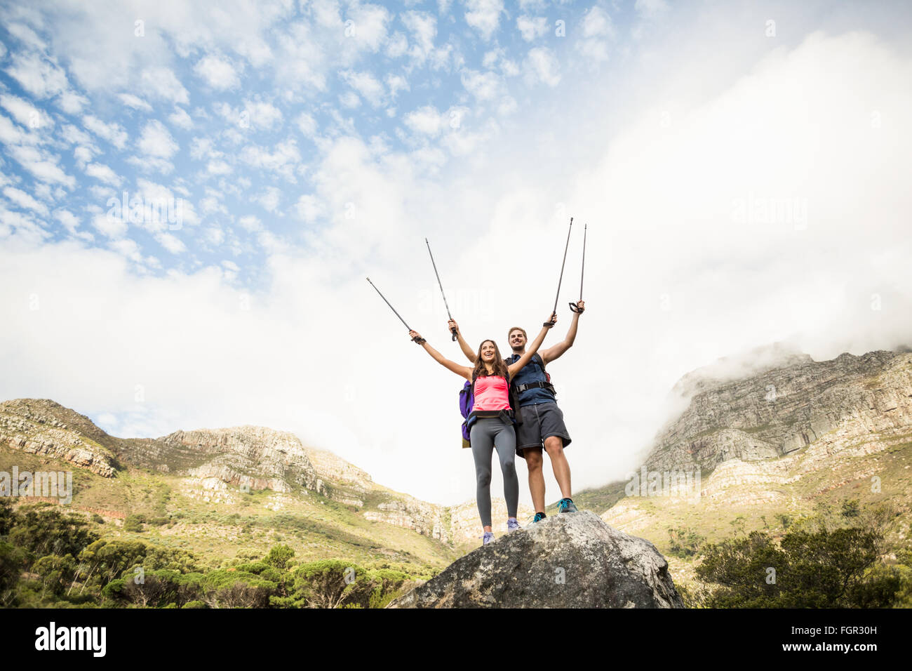 Young happy joggers standing on rock cheering Stock Photo - Alamy