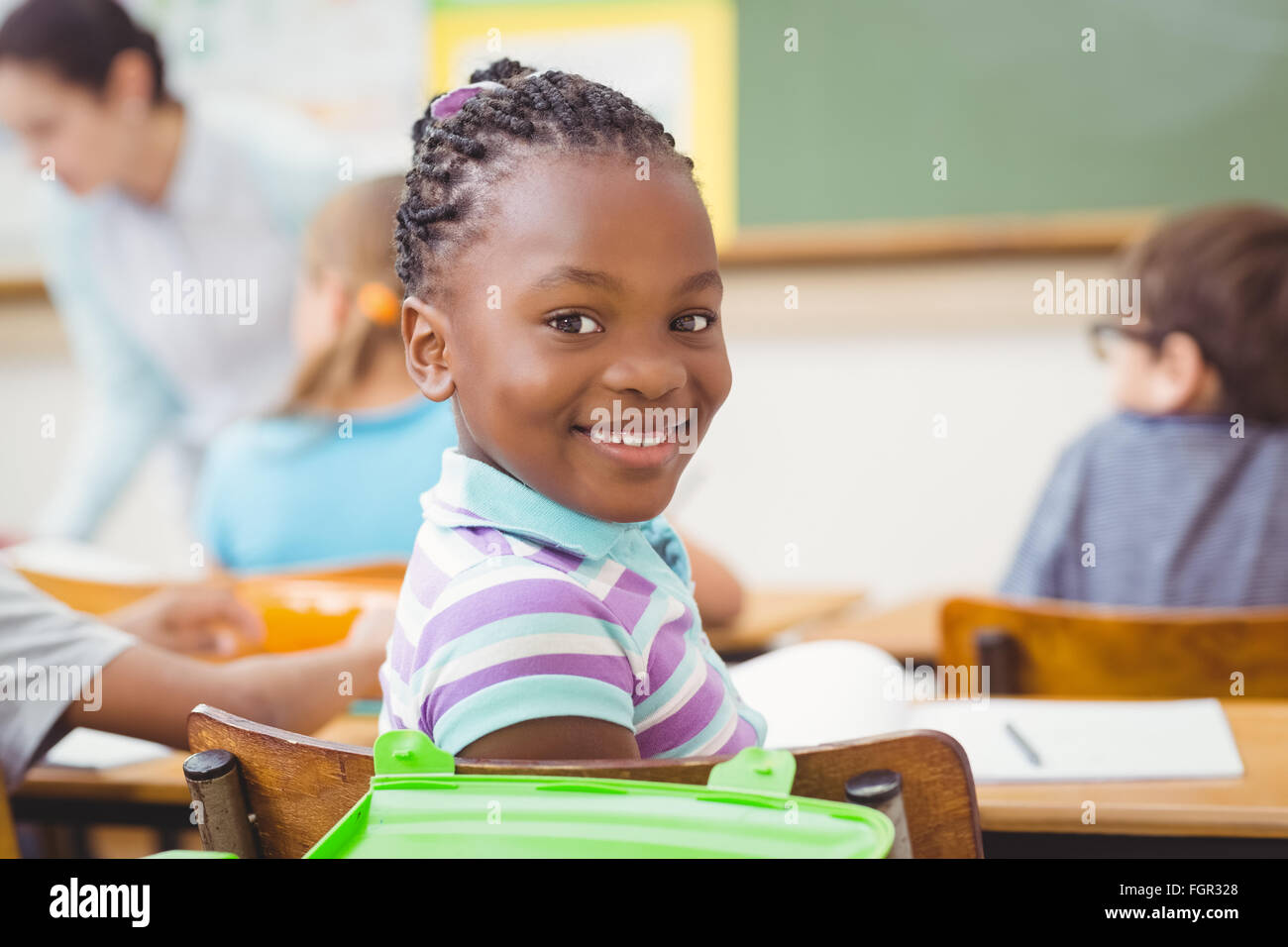 Pupil smiling at camera during class Stock Photo - Alamy