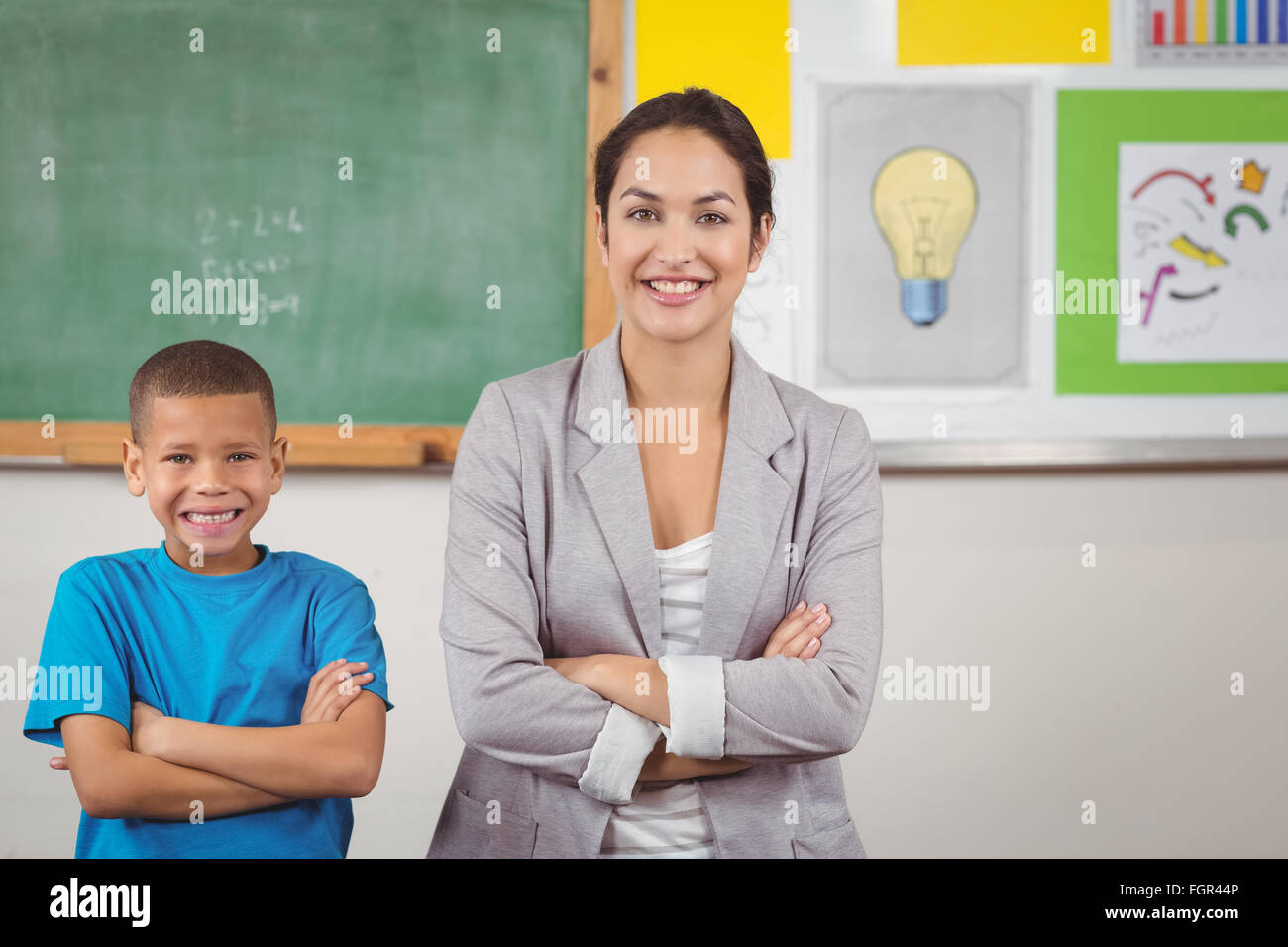 Pretty teacher and cute pupil in front of chalkboard Stock Photo - Alamy