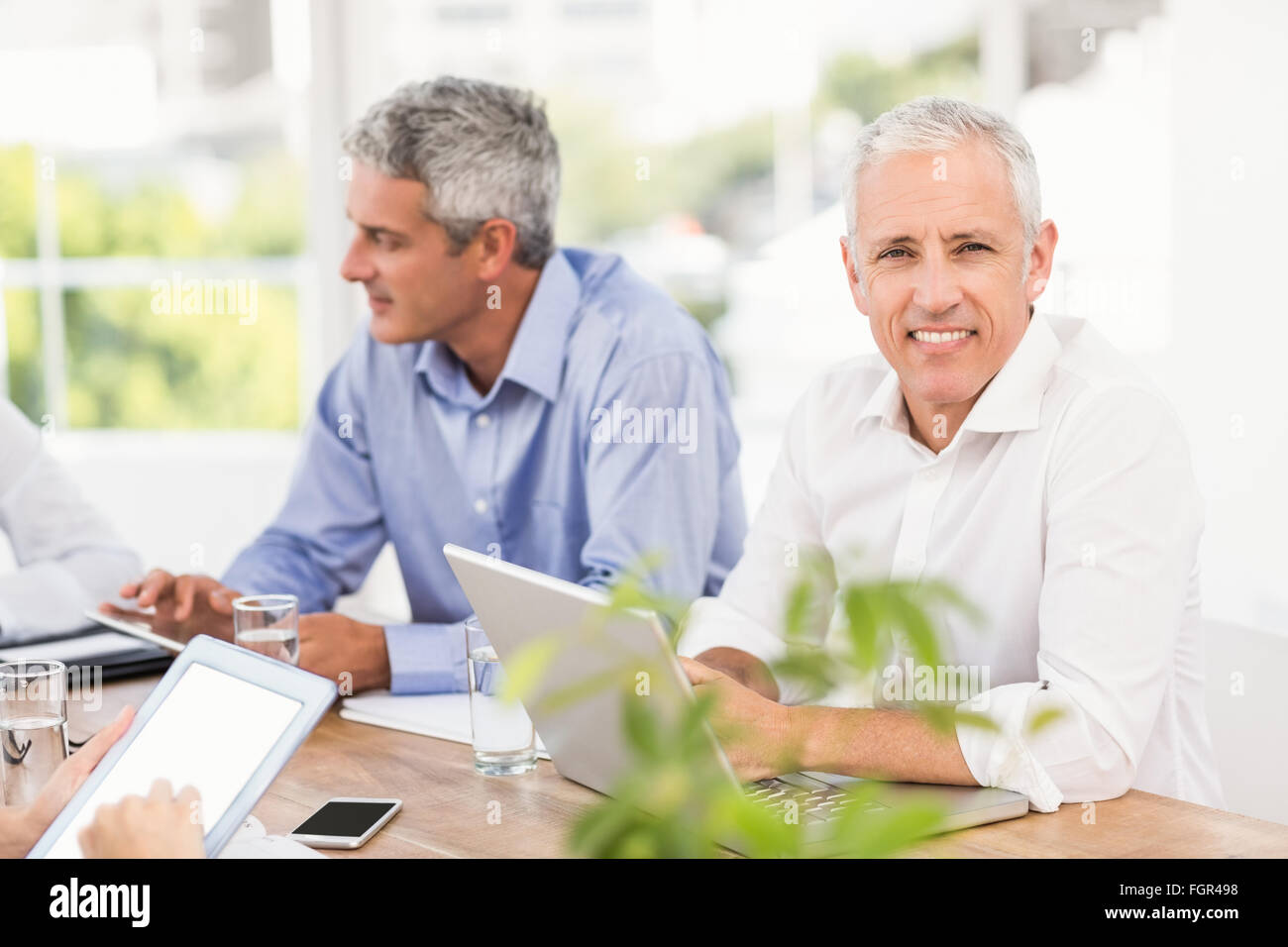 Smiling businessman during a meeting Stock Photo - Alamy