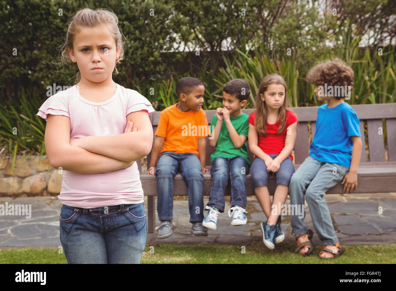 Upset child standing away from group Stock Photo - Alamy