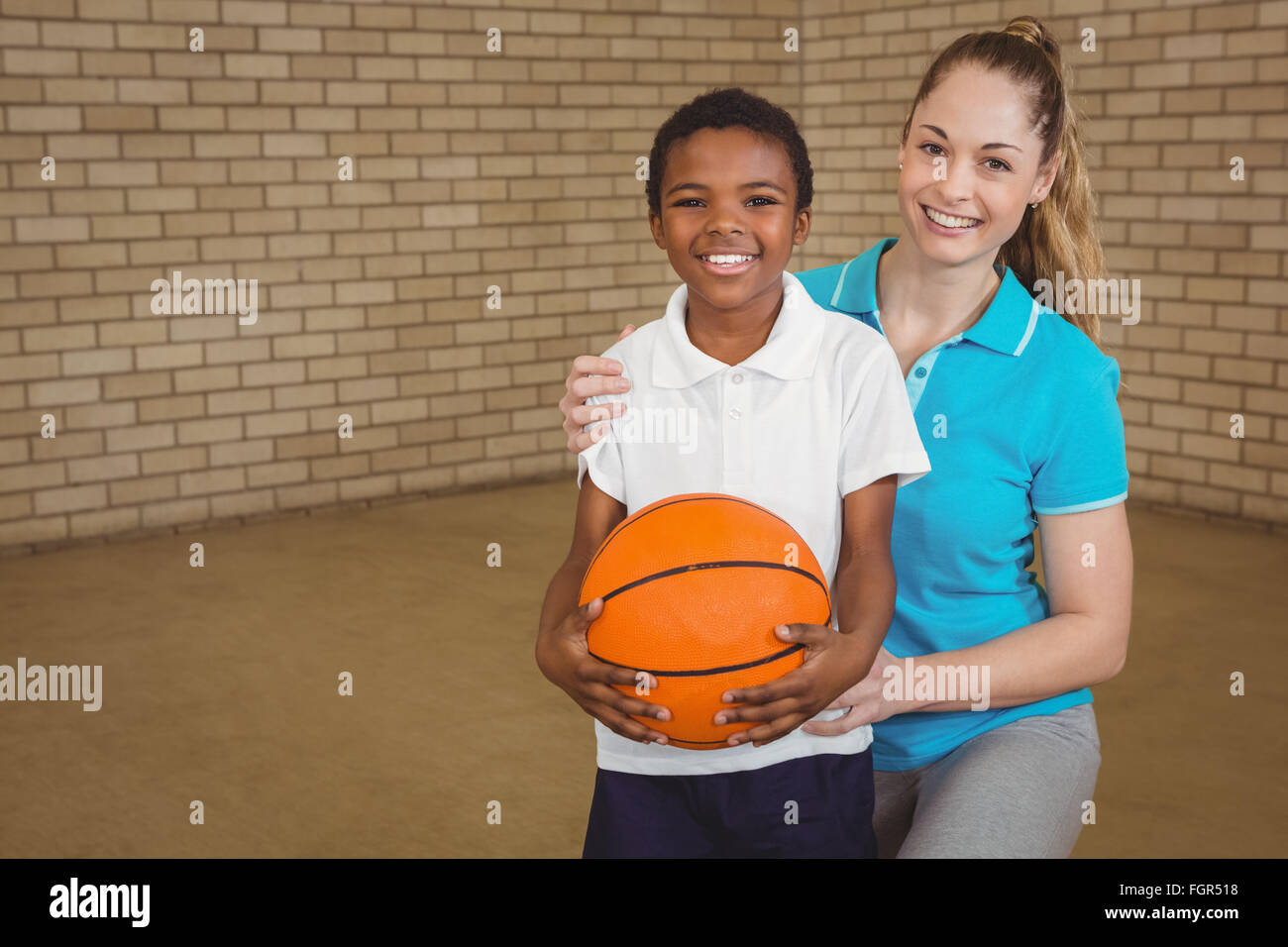 Student holding basketball with teacher Stock Photo - Alamy