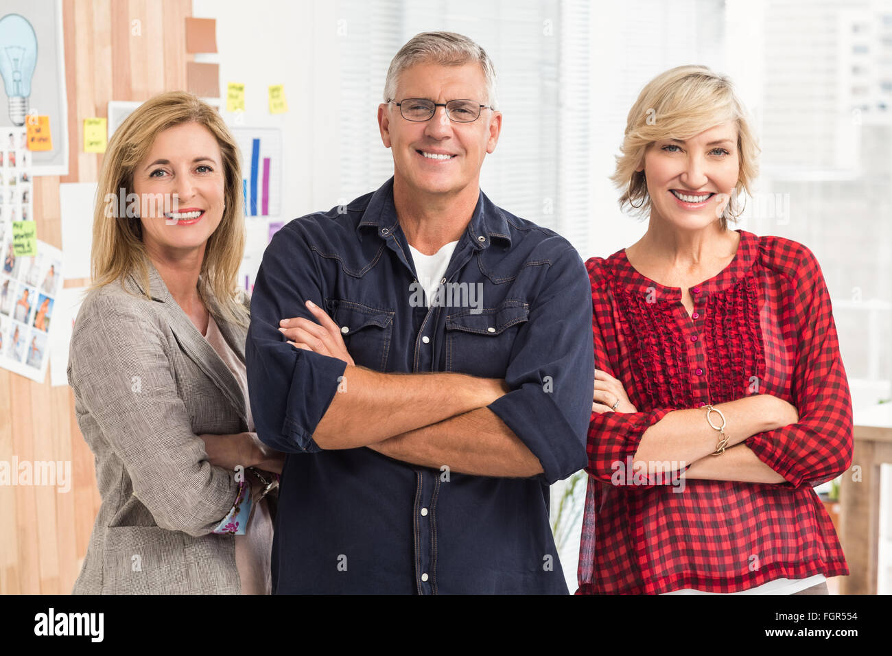 Smiling business team looking at the camera Stock Photo - Alamy