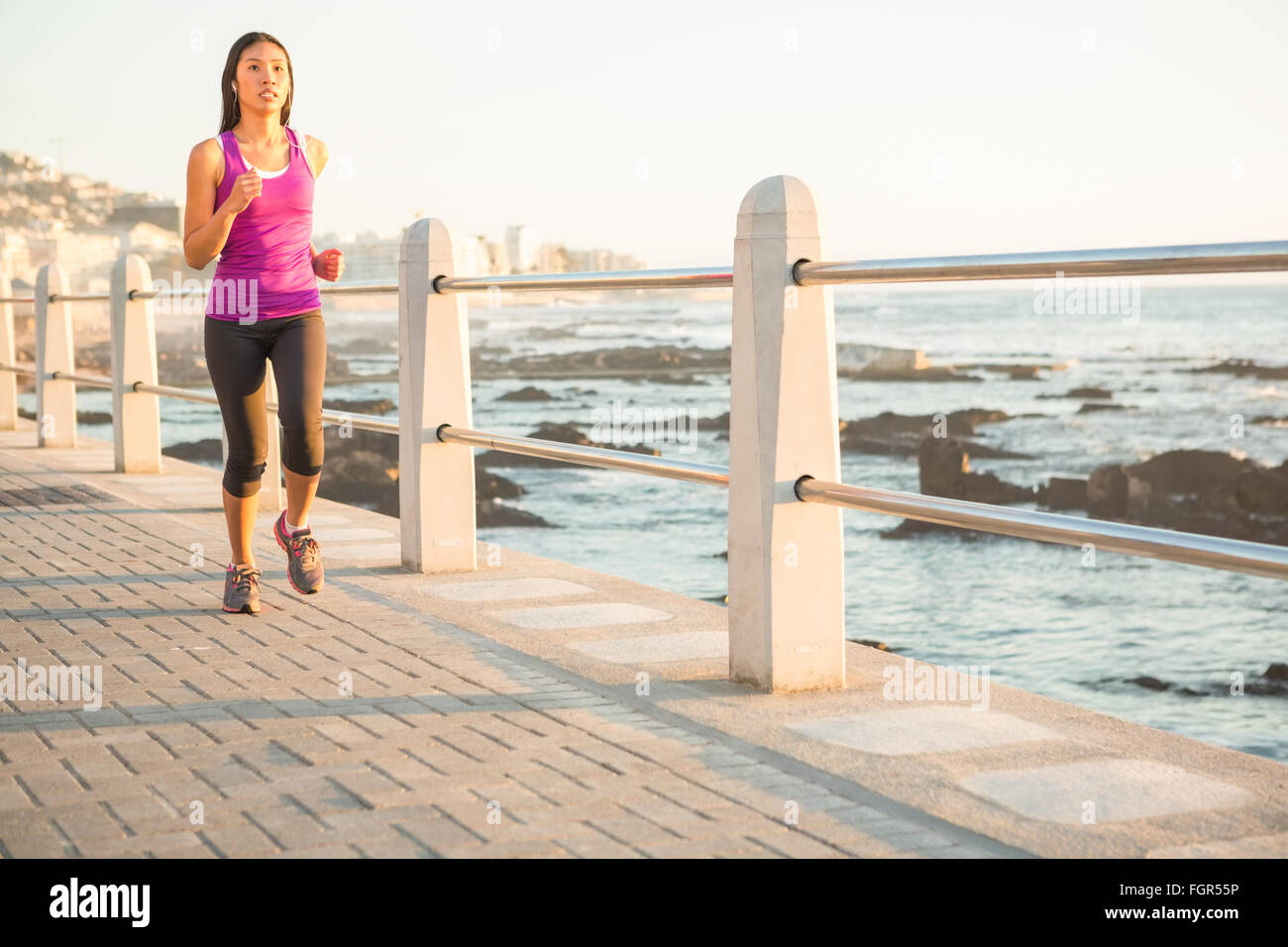 Fit woman jogging at promenade Stock Photo - Alamy