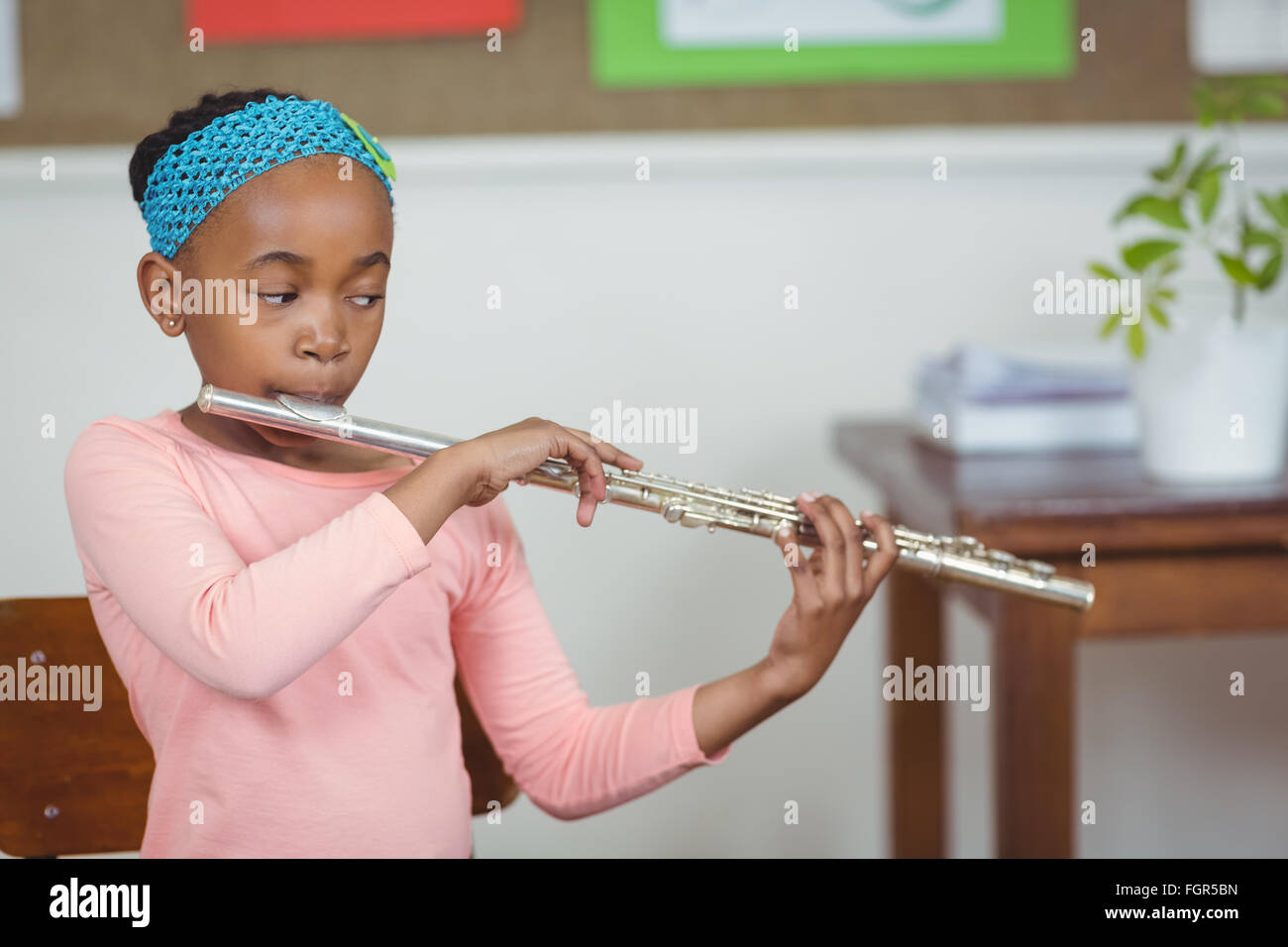 Cute pupil playing flute in a classroom Stock Photo - Alamy