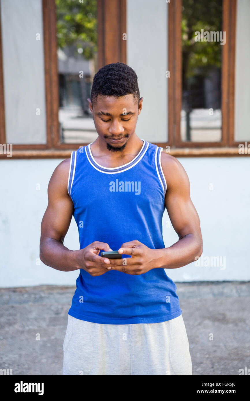 An handsome athlete using his phone Stock Photo - Alamy