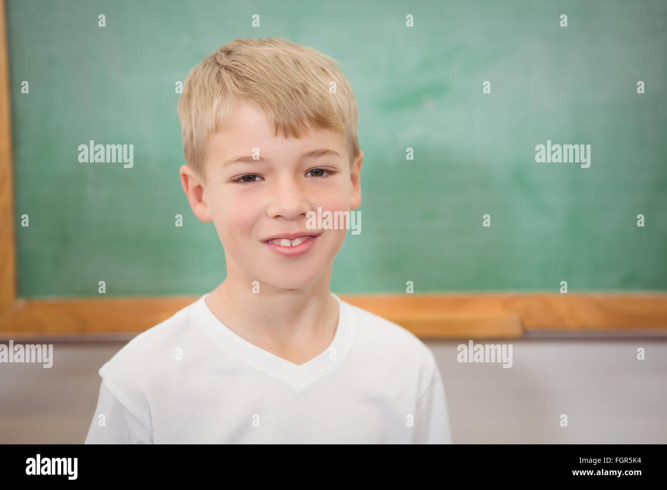 Smiling student in front of blackboard Stock Photo - Alamy