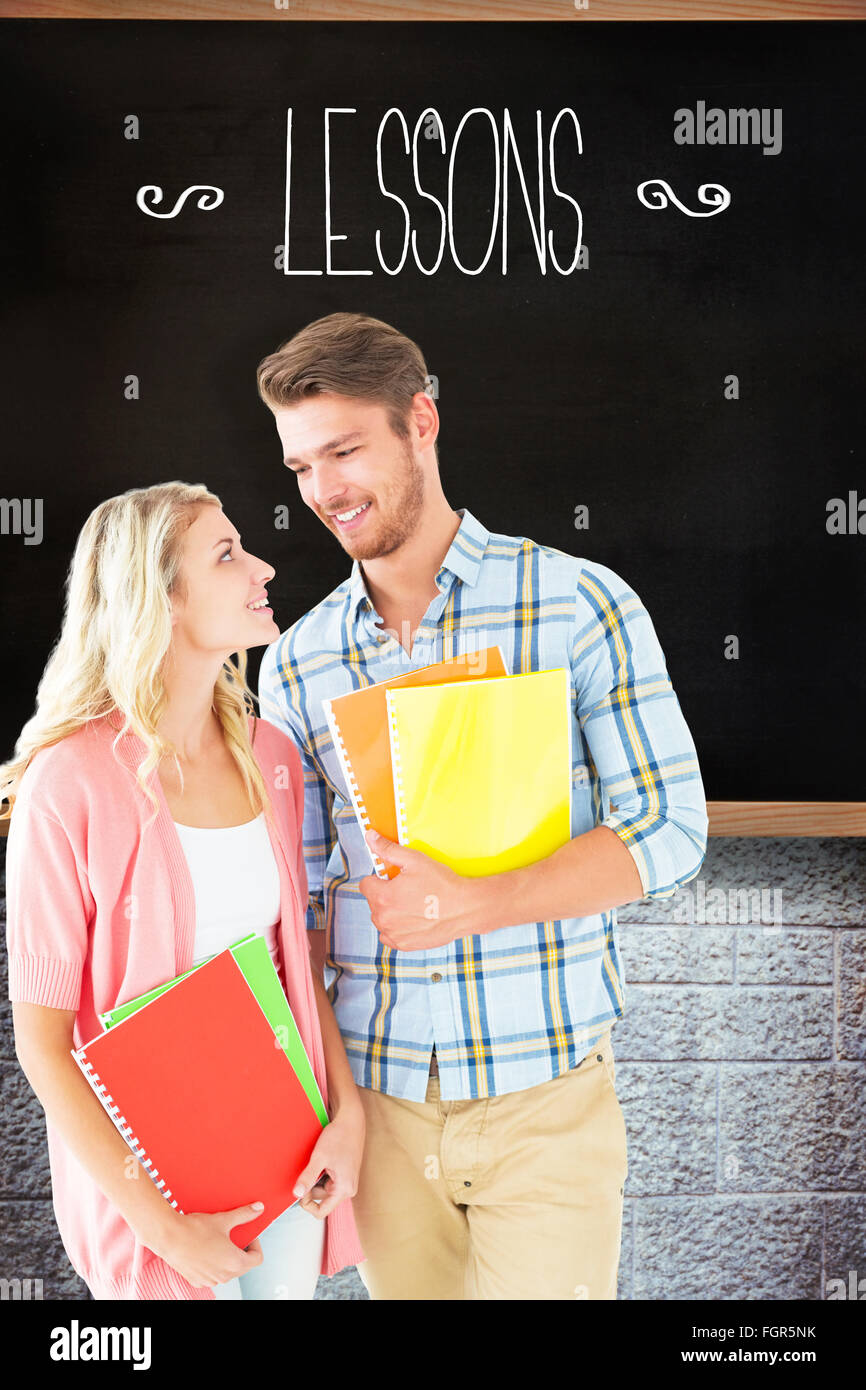 Lessons against chalkboard in classroom Stock Photo - Alamy