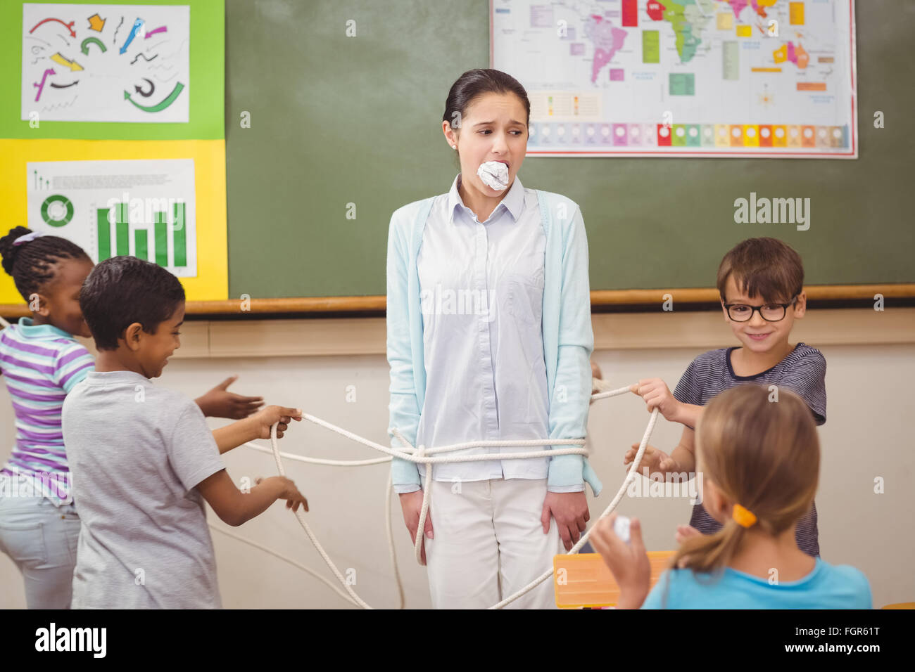 Pupils running wild in classroom Stock Photo - Alamy