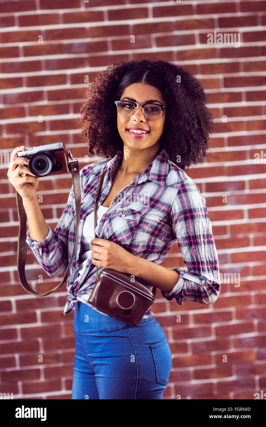 Attractive smiling hipster posing with camera Stock Photo - Alamy