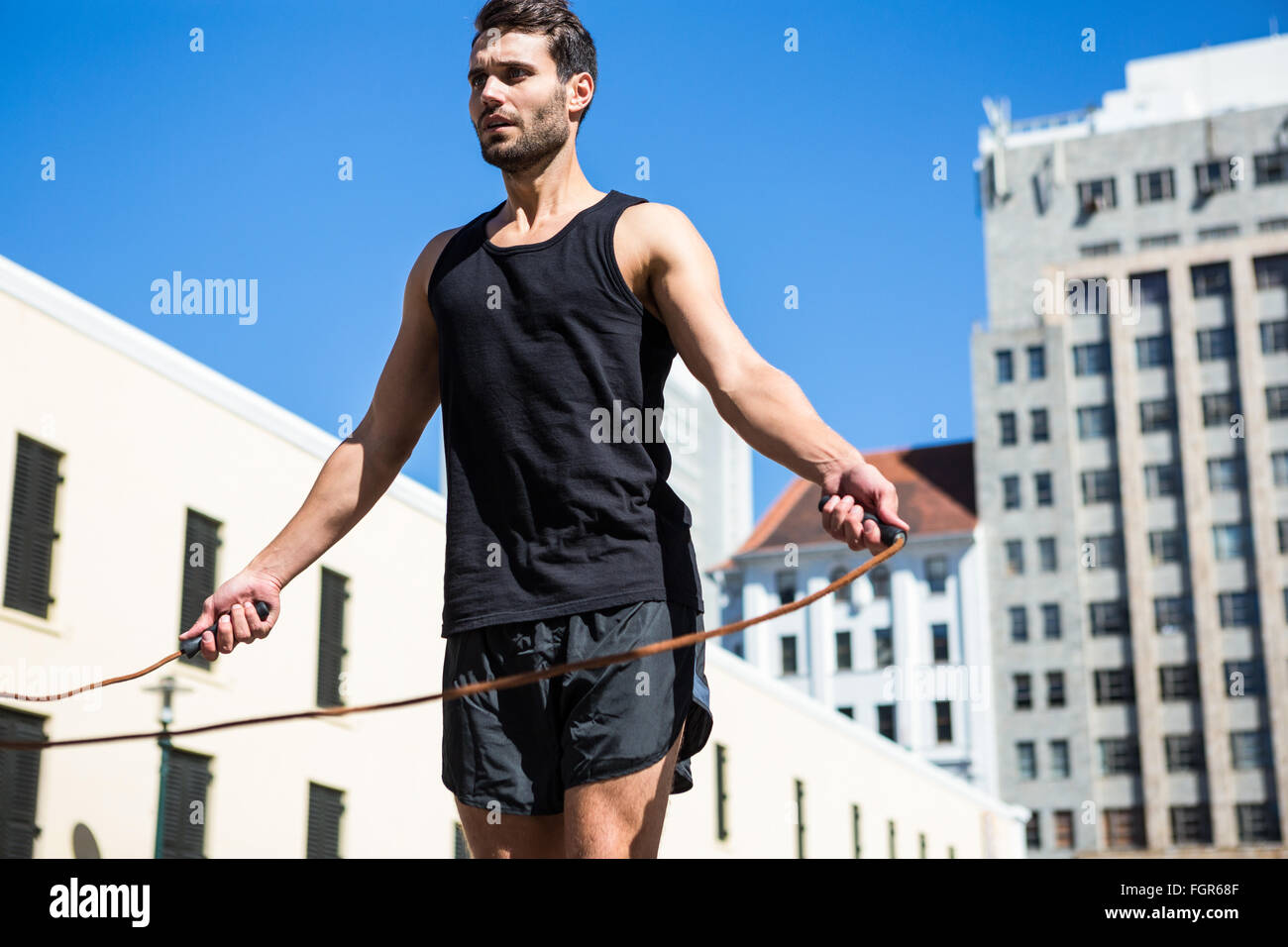 Handsome athlete doing jumping rope Stock Photo - Alamy