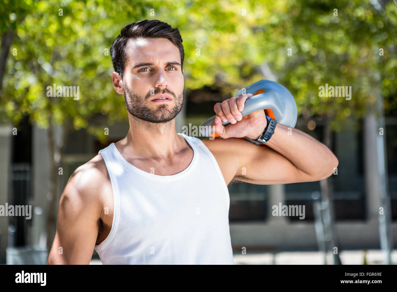 Handsome athlete outfit with a kettlebell Stock Photo - Alamy