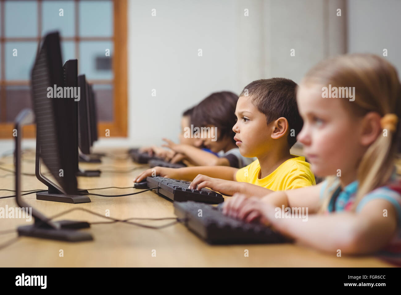 Cute pupils in computer class Stock Photo - Alamy