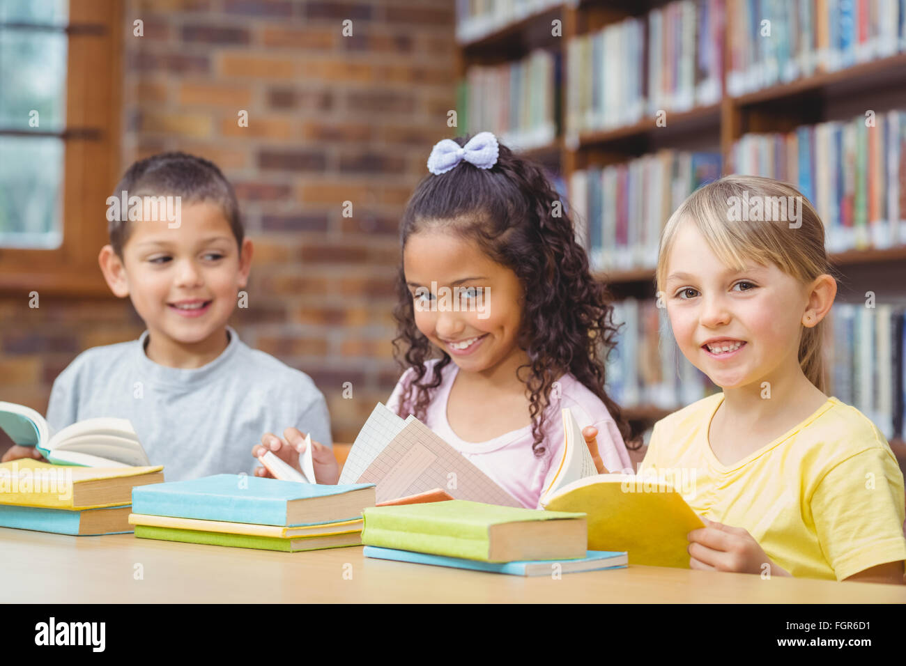 Pupils reading books in library Stock Photo - Alamy